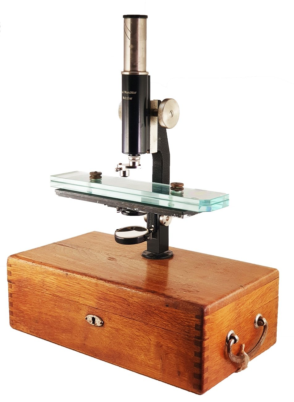 A microscope on a wooden tableDescription automatically generated
